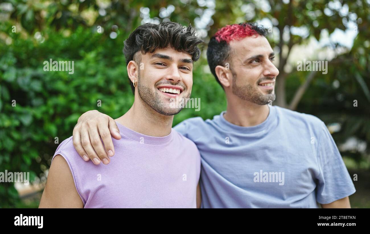 Two men couple smiling confident hugging each other at park Stock Photo ...