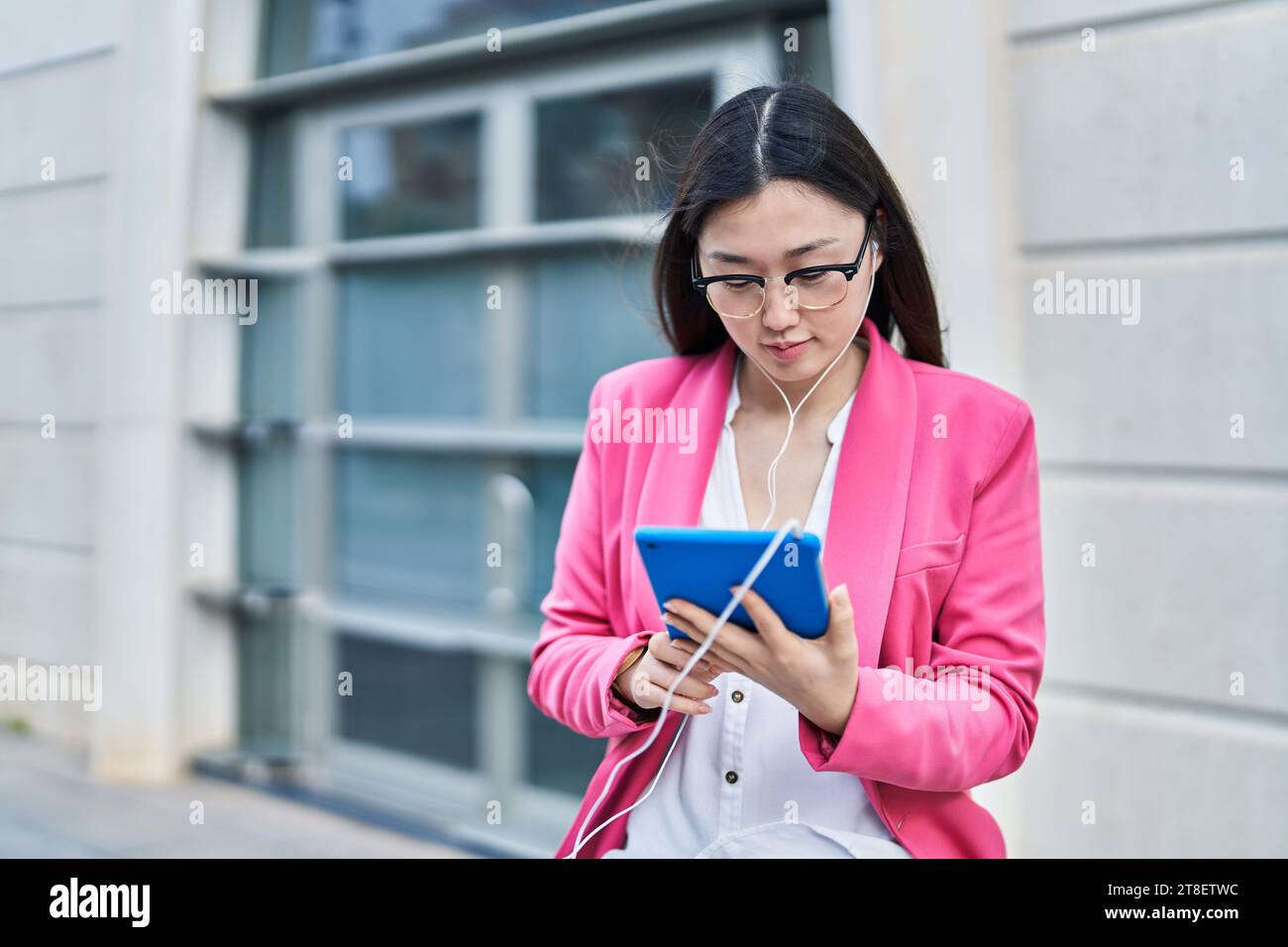 Chinese woman business worker using touchpad at street Stock Photo - Alamy