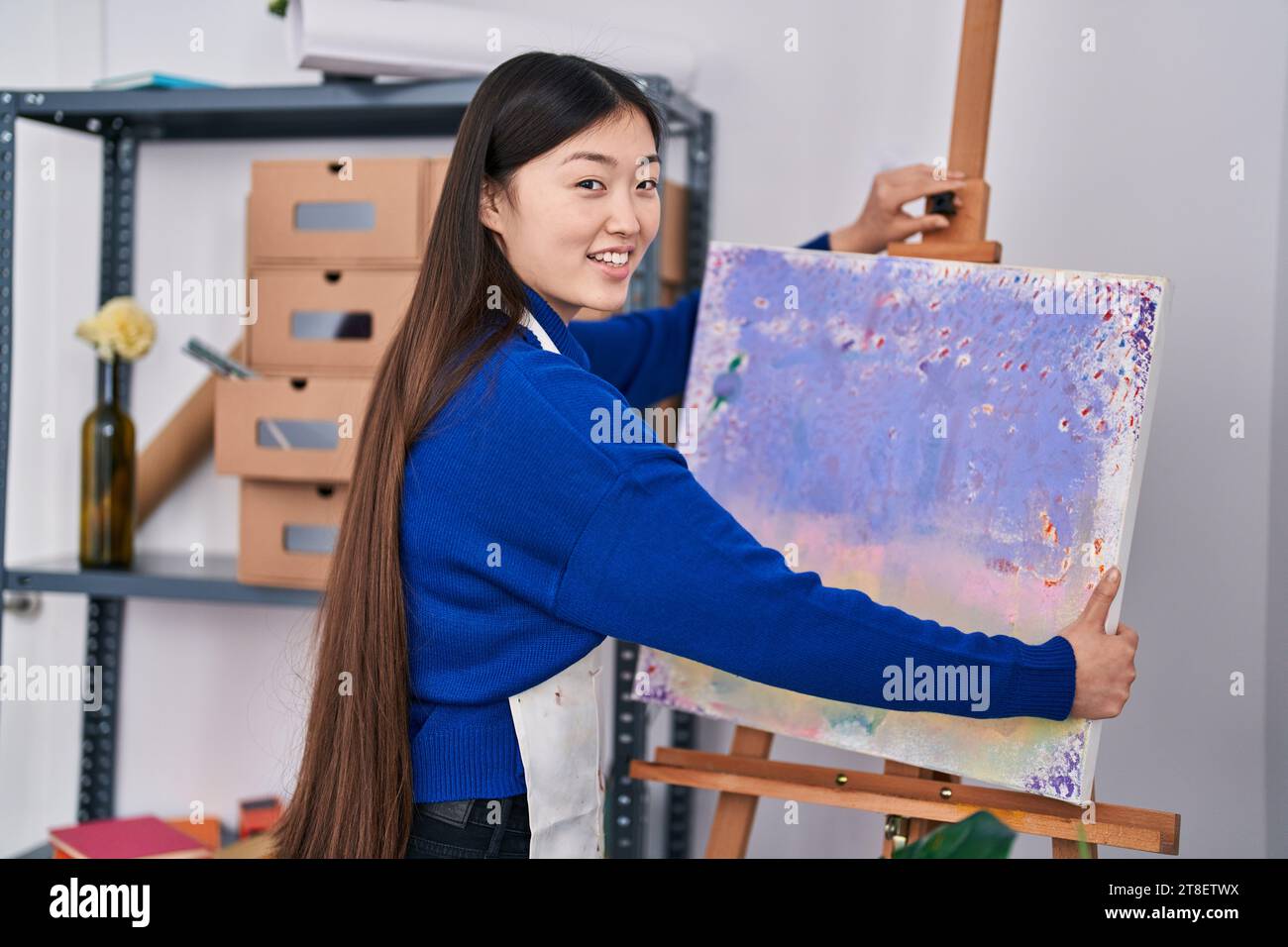 Chinese woman artist smiling confident holding draw at art studio Stock ...