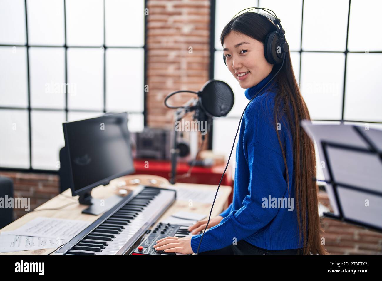 Chinese woman musician having dj session at music studio Stock Photo ...