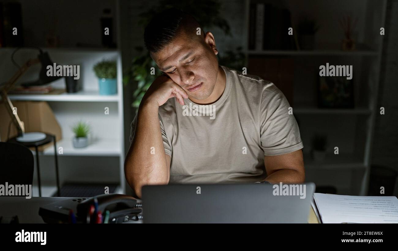 Exhausted young latin business worker, a picture of tired success ...