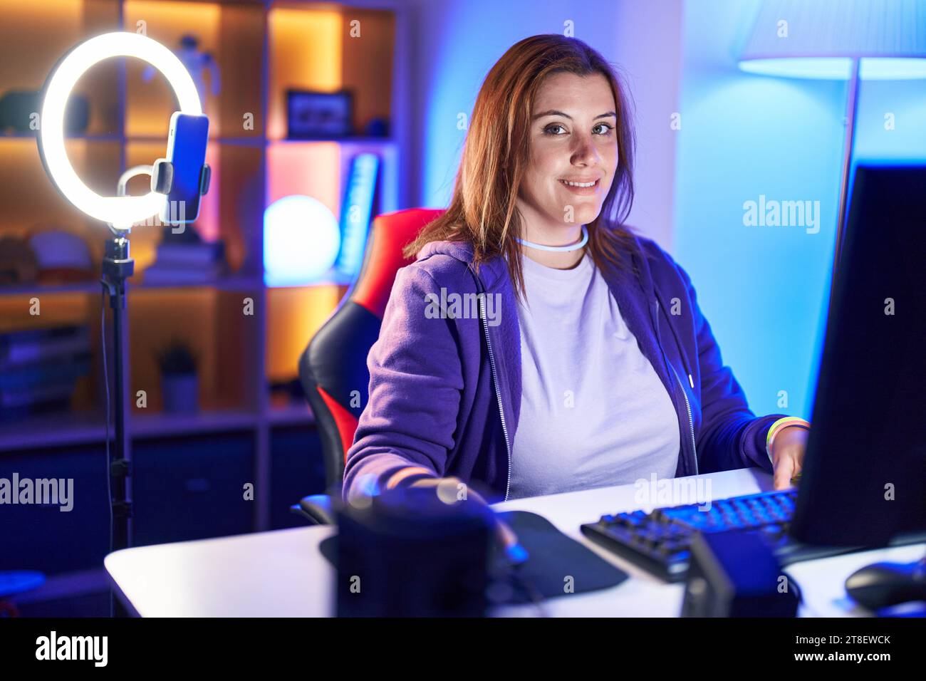 Young beautiful plus size woman streamer playing video game using ...