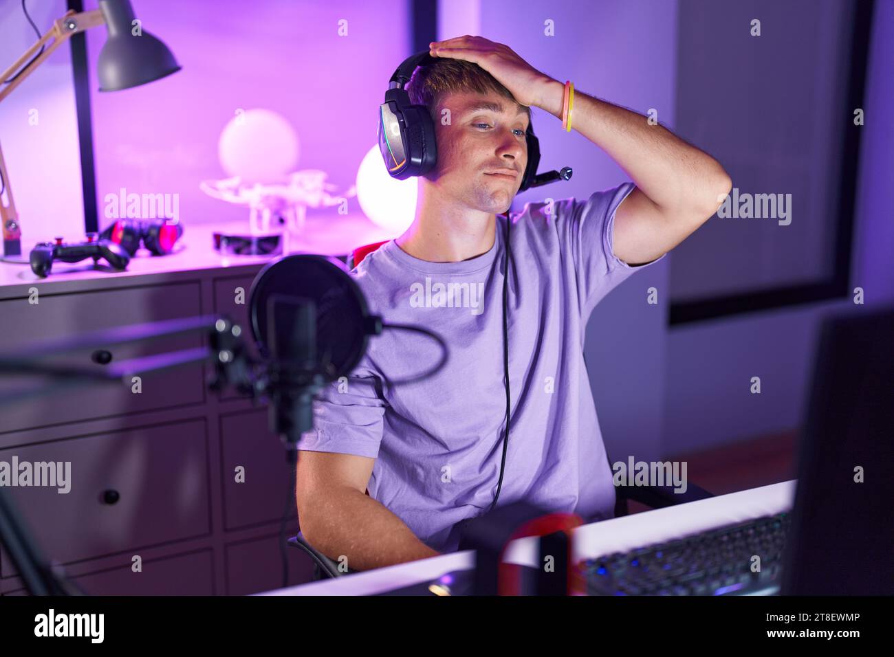 Young caucasian man streamer stressed using computer at gaming room ...