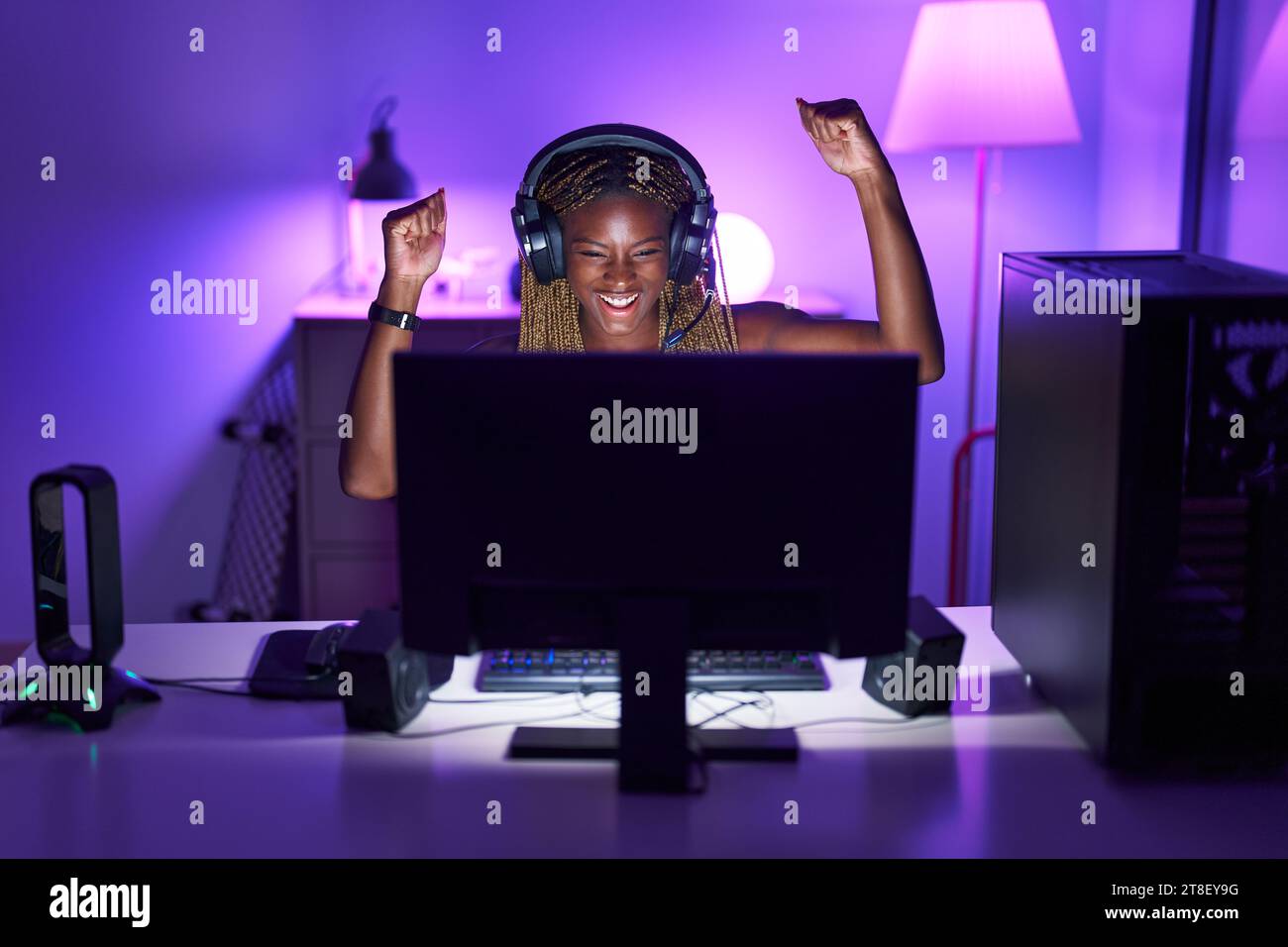 African american woman streamer playing video game with winner ...