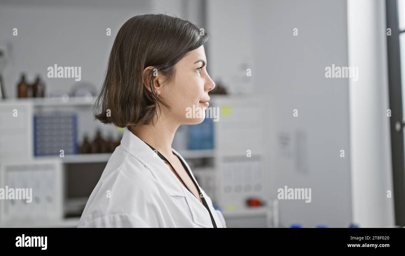 Focused young and beautiful hispanic female scientist with a serious ...