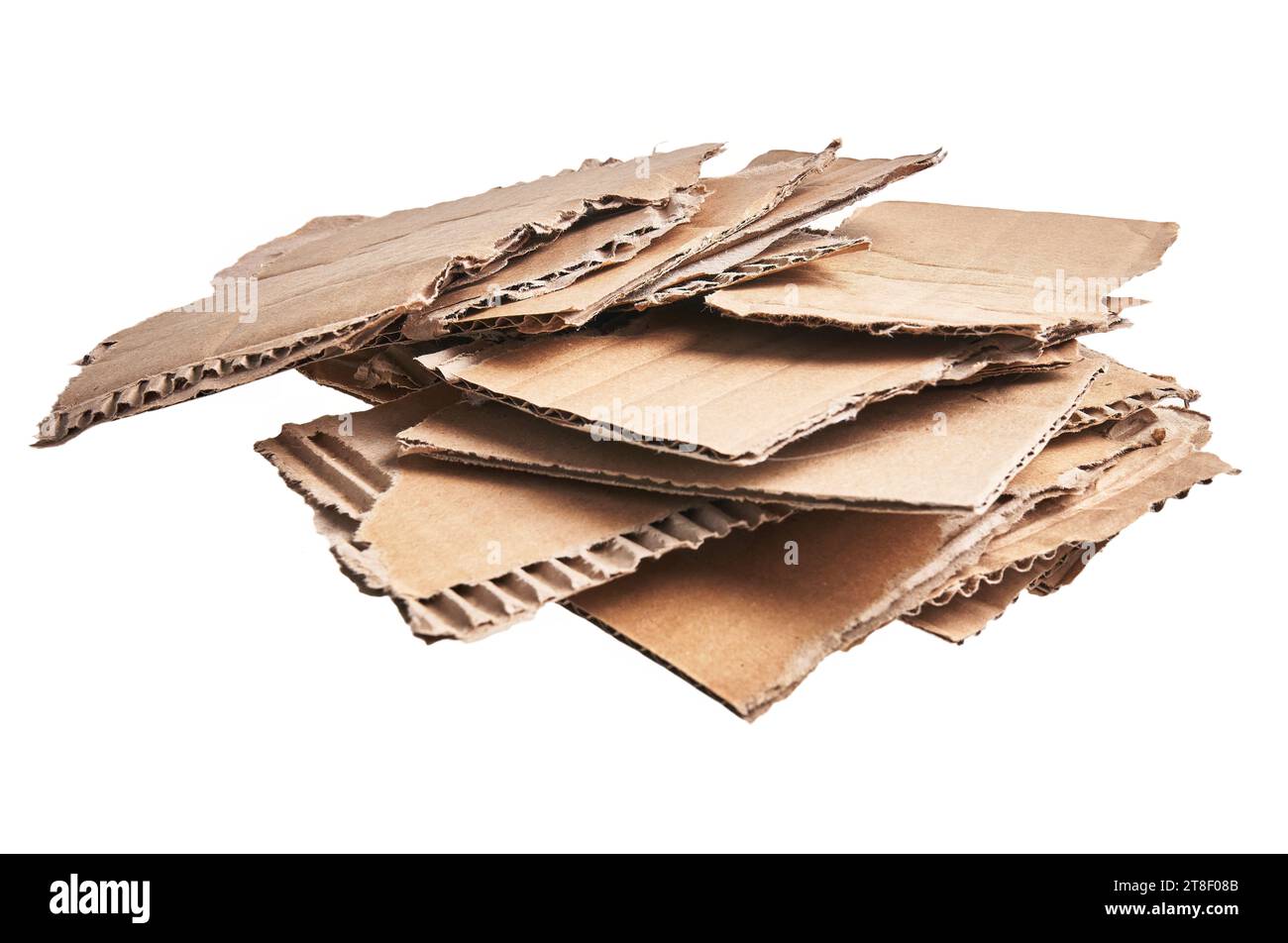 Stack of ripped pieces of cardboard material over isolated white ...