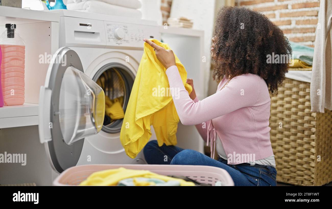 African american woman washing clothes at laundry room Stock Photo - Alamy