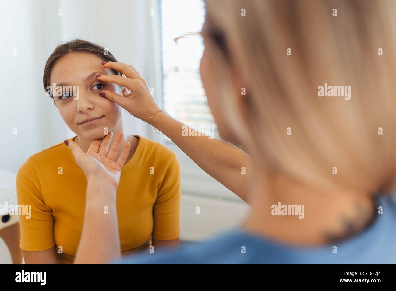 Pediatrician examining eyes of a teenage patient.The ophthalmologist ...