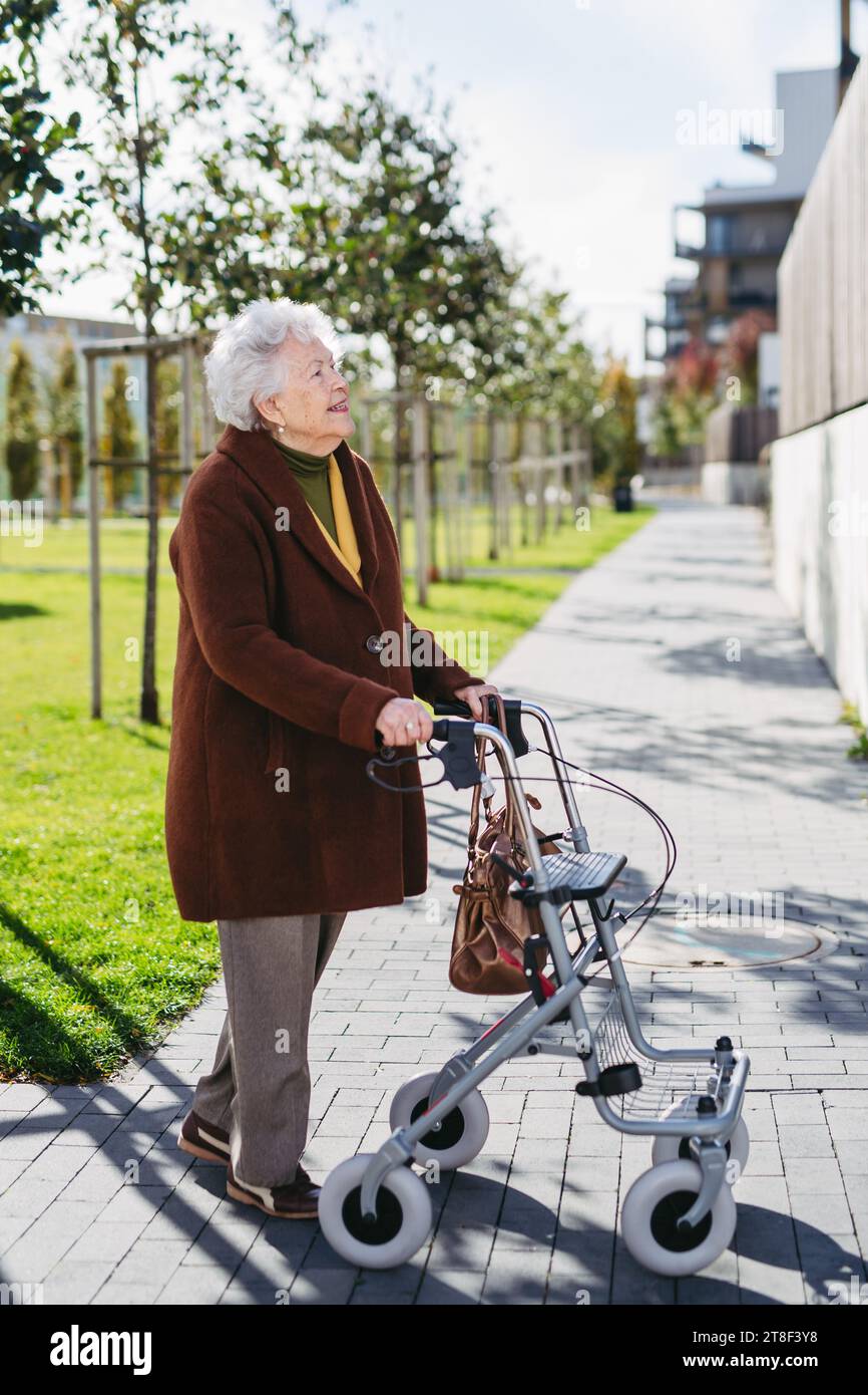 Elderly lady during walking walker hi-res stock photography and images ...