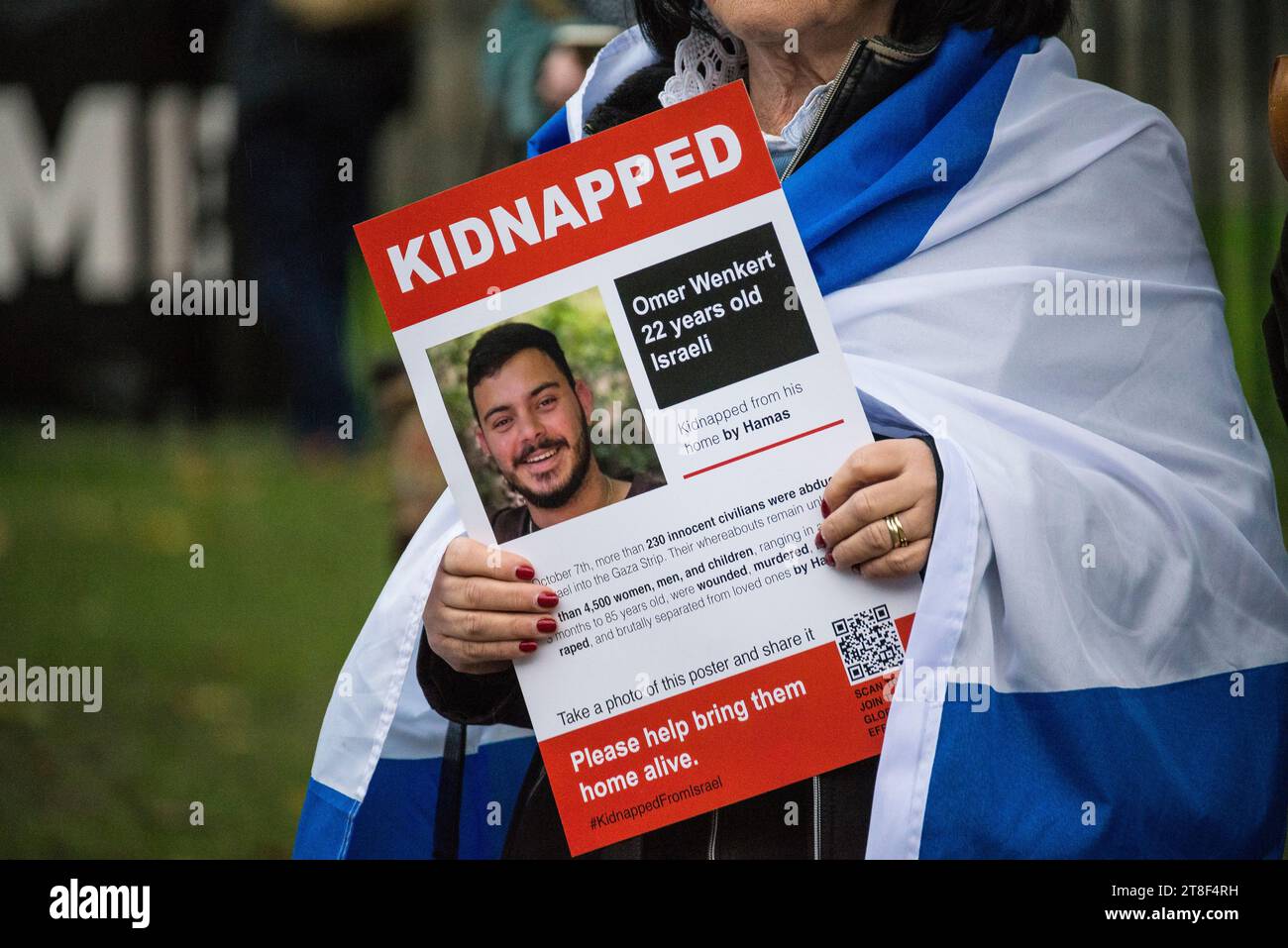 Woman holding a photo of a hostage kidnapped by Hamas, 'Never Again Is ...