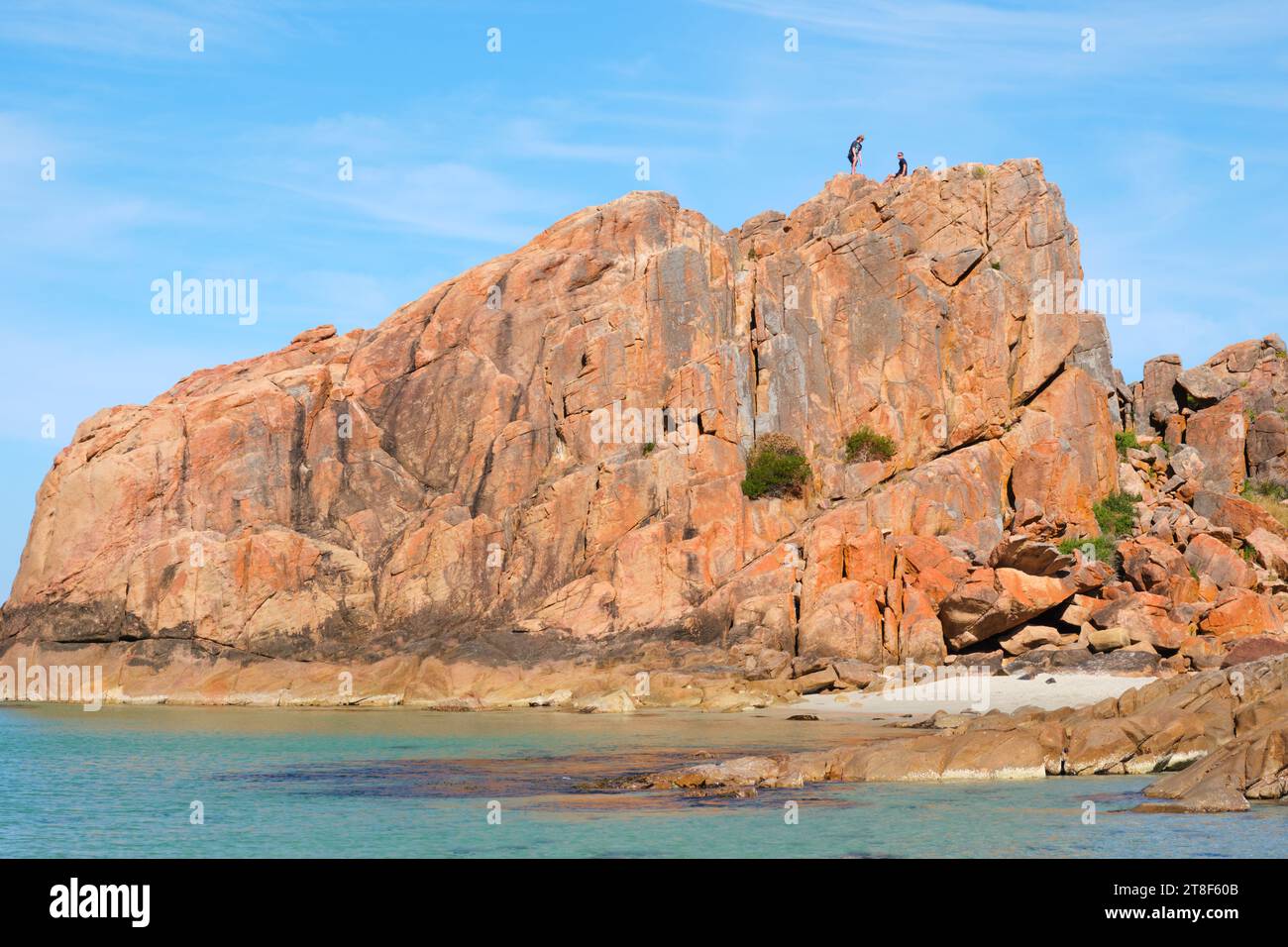 Two young men on top of the granite rock formation of Castle Rock ...