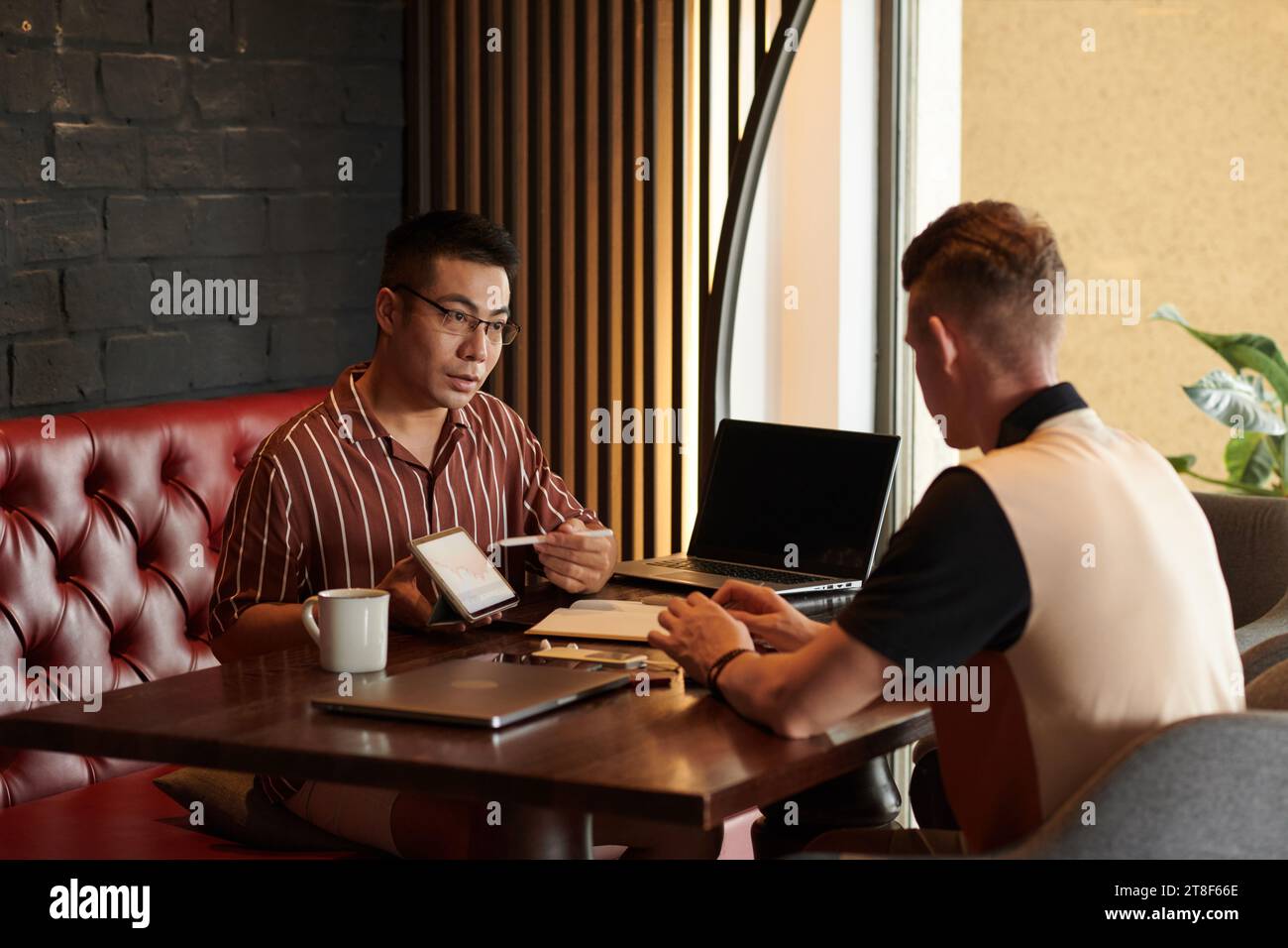 Trader explaining client how to read stock market charts when learning ...