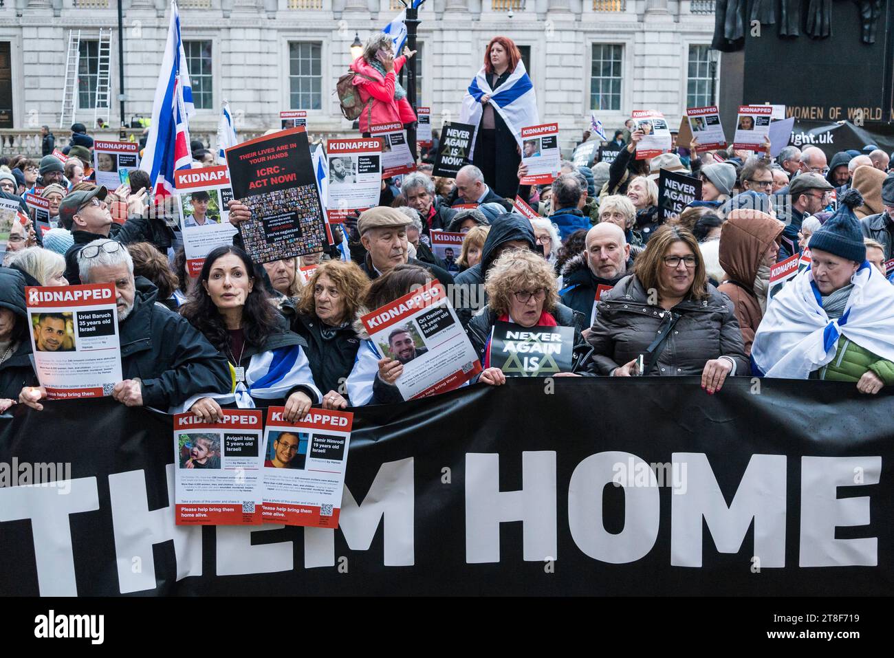 Protestors holding pictures of people kidnapped by Hamas, 'Never Again ...