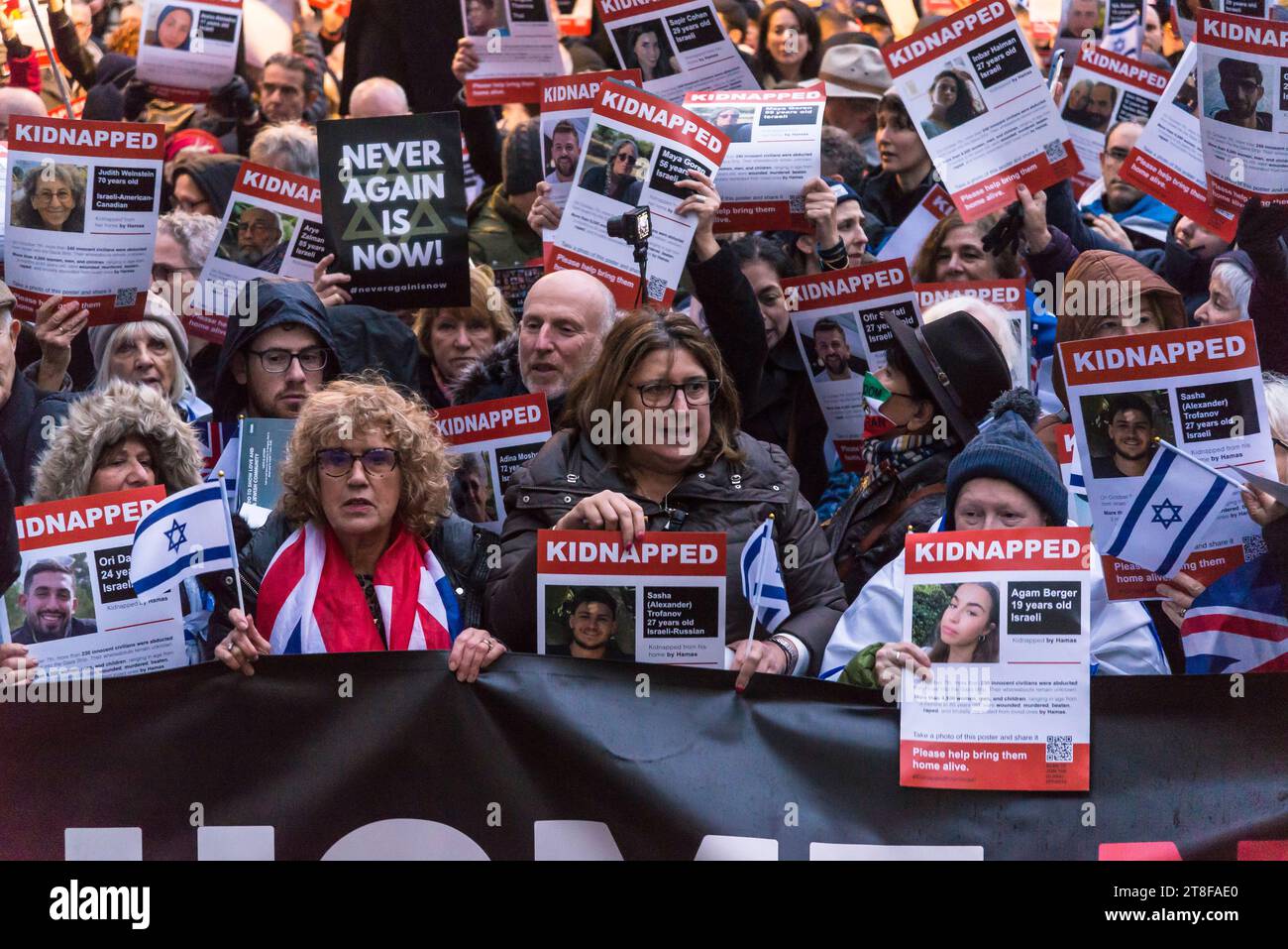 Protestors holding pictures of people kidnapped by Hamas, 'Never Again ...
