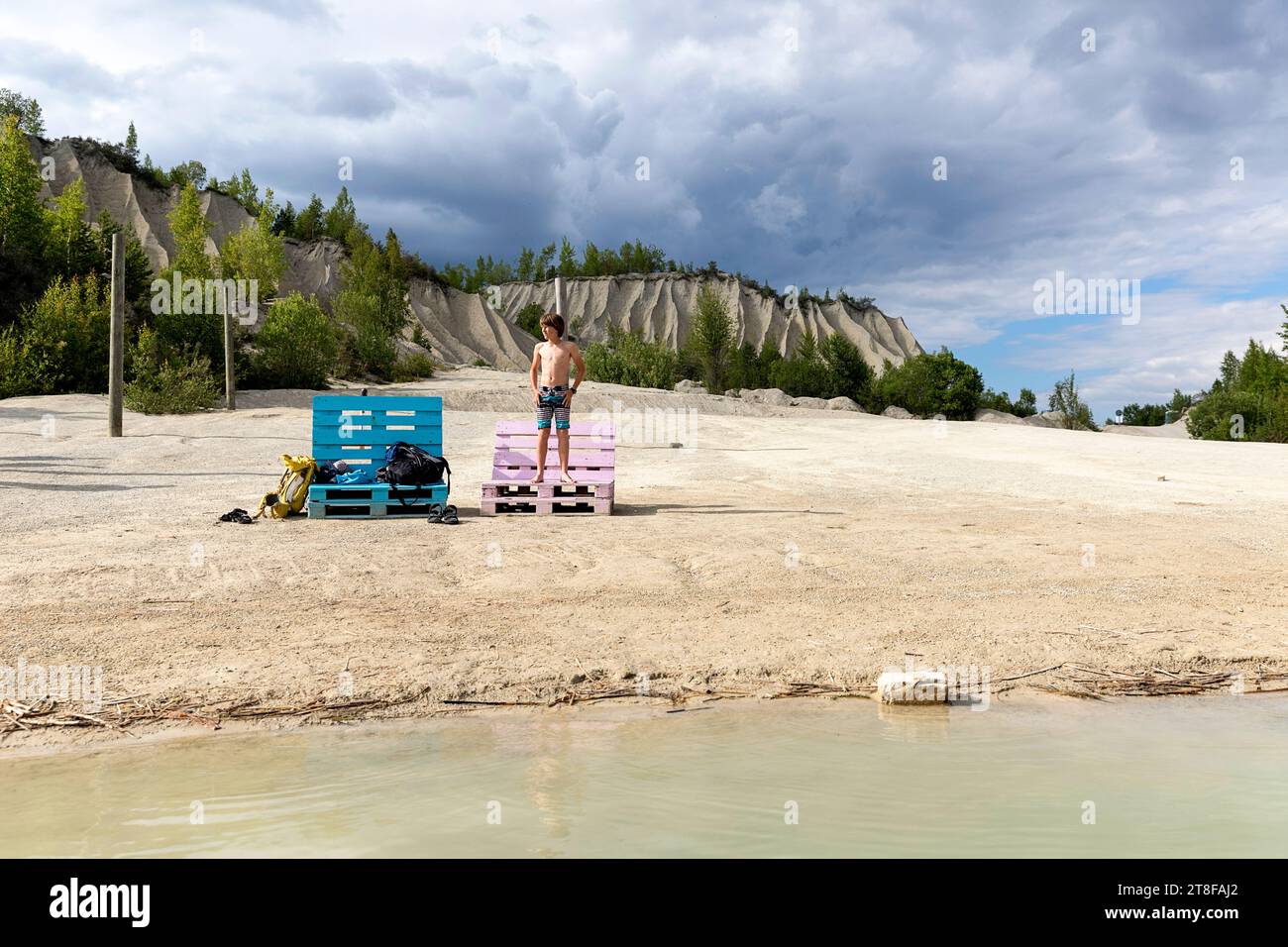 Tourist relaxing on a beach in Scenic Rummu quarry, former prison that ...