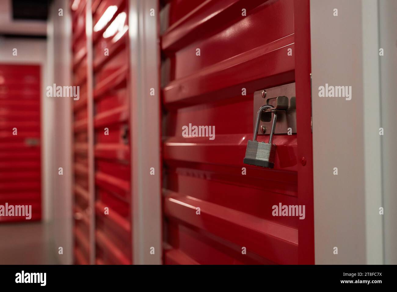 Lock on closed door of storage unit with belongings of customer Stock ...