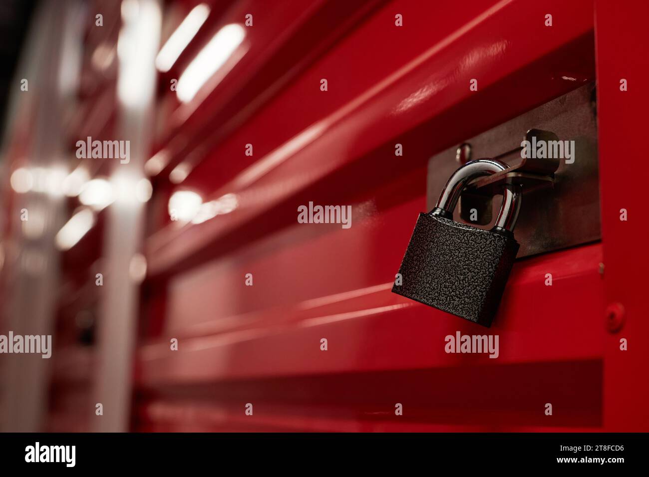 Padlock on closed red metal door in warehouse Stock Photo - Alamy