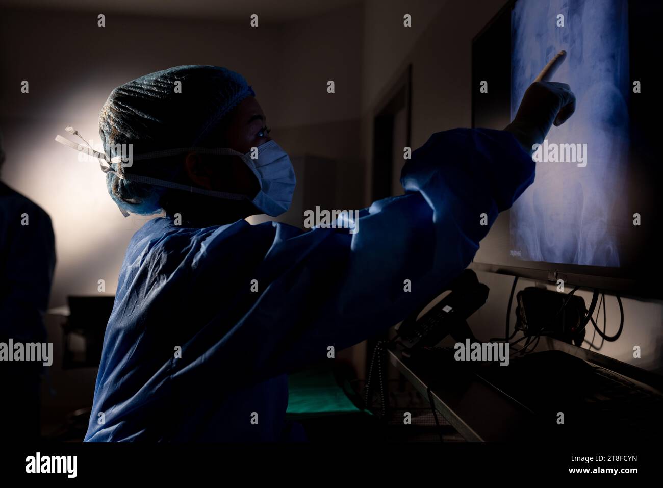 Asian female doctor with face mask looking at x-ray in hospital Stock ...