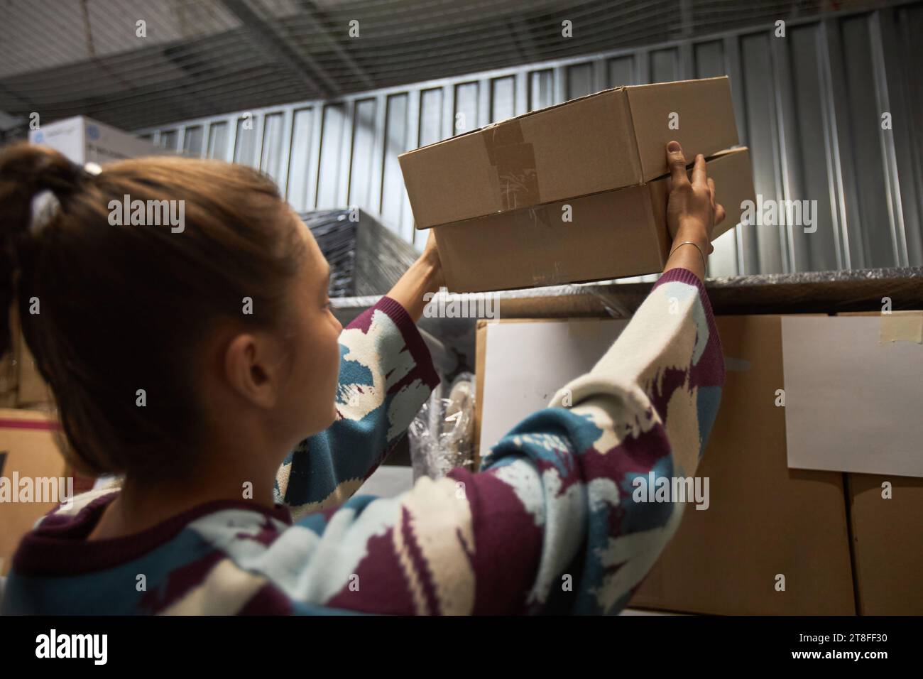 Putting box on shelf hi-res stock photography and images - Alamy
