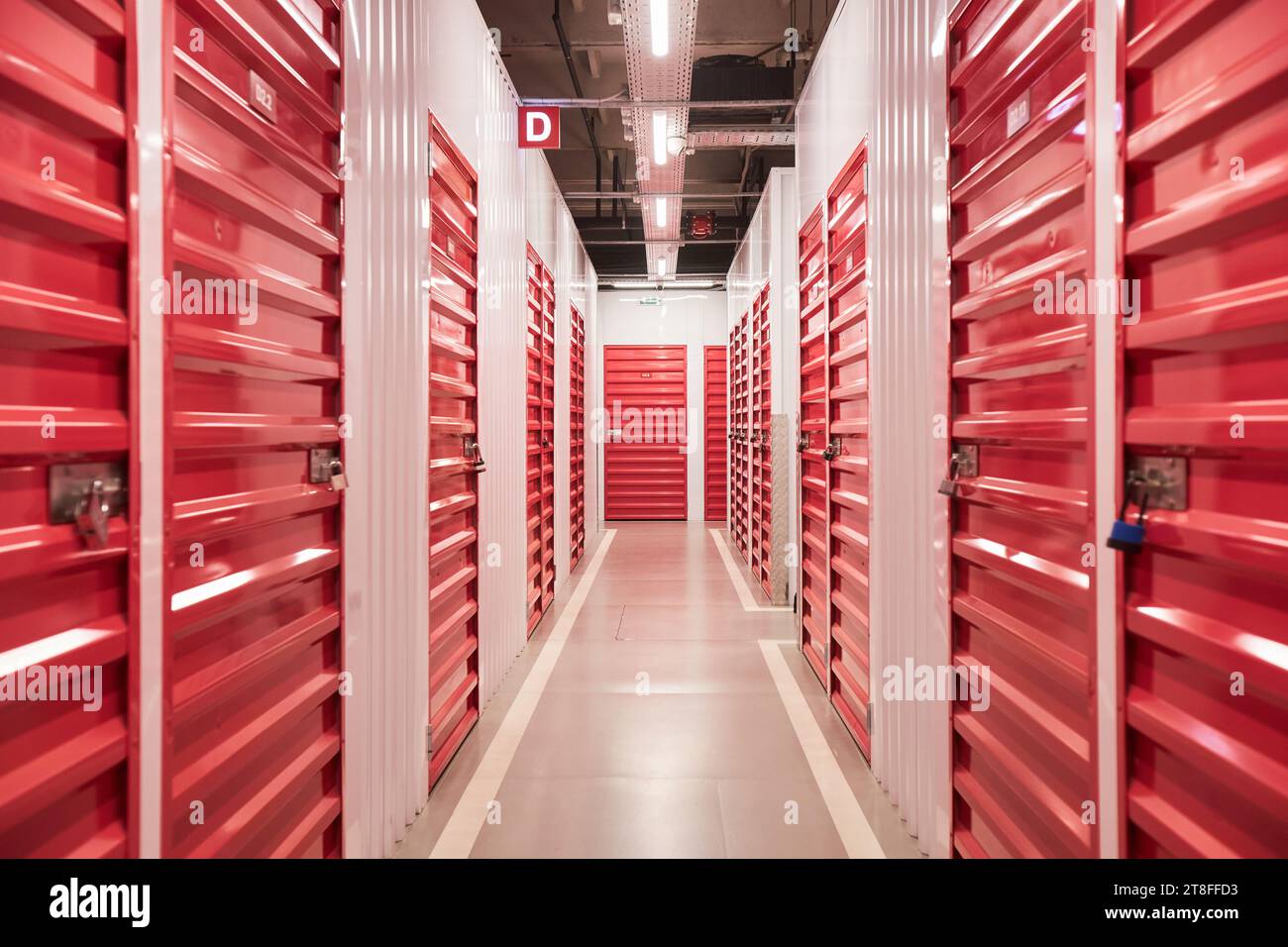Locked red doors in corridor of self-storage facility Stock Photo - Alamy