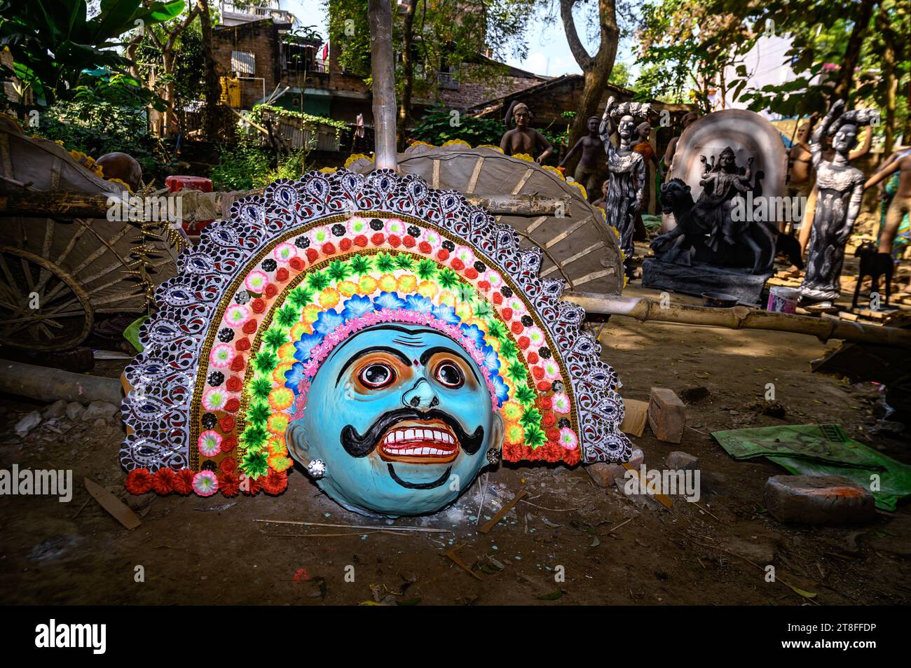 A village idol artist makes large color masks modeled after Purulia ...