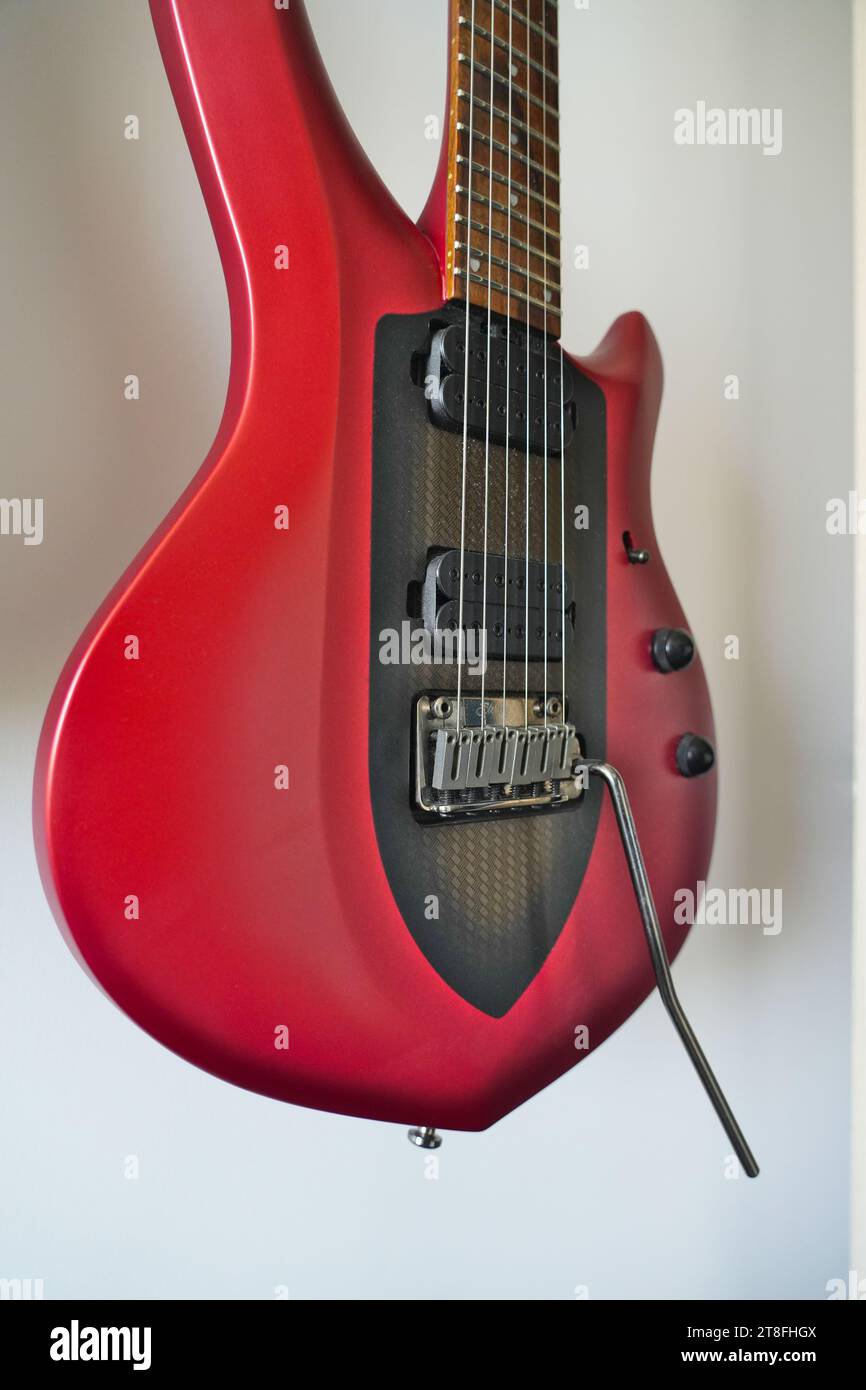 Red fire bodied electric guitar with six strings on the black gradient ...