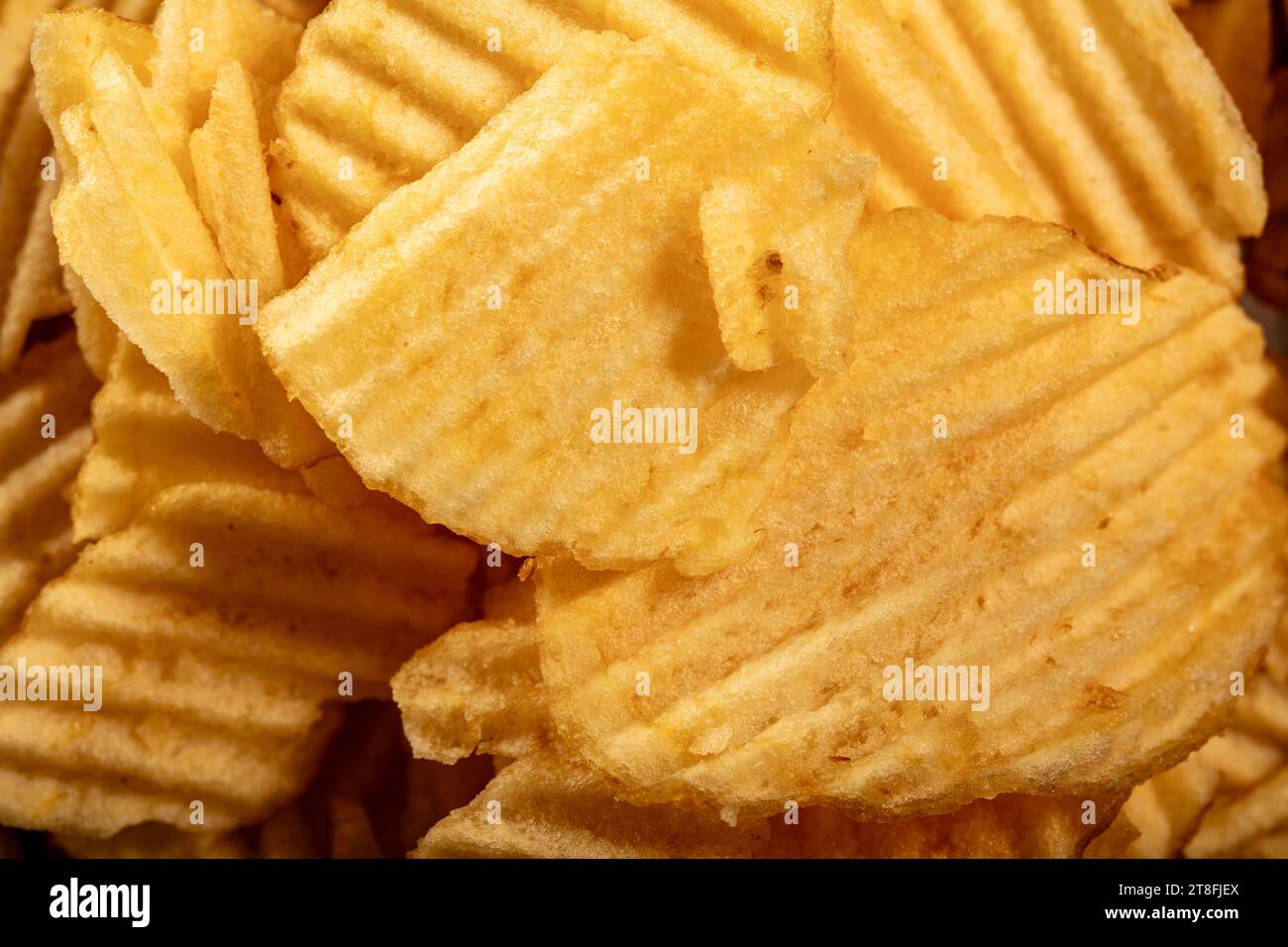 Close up snack food still life of crinkle cut crisps Stock Photo - Alamy