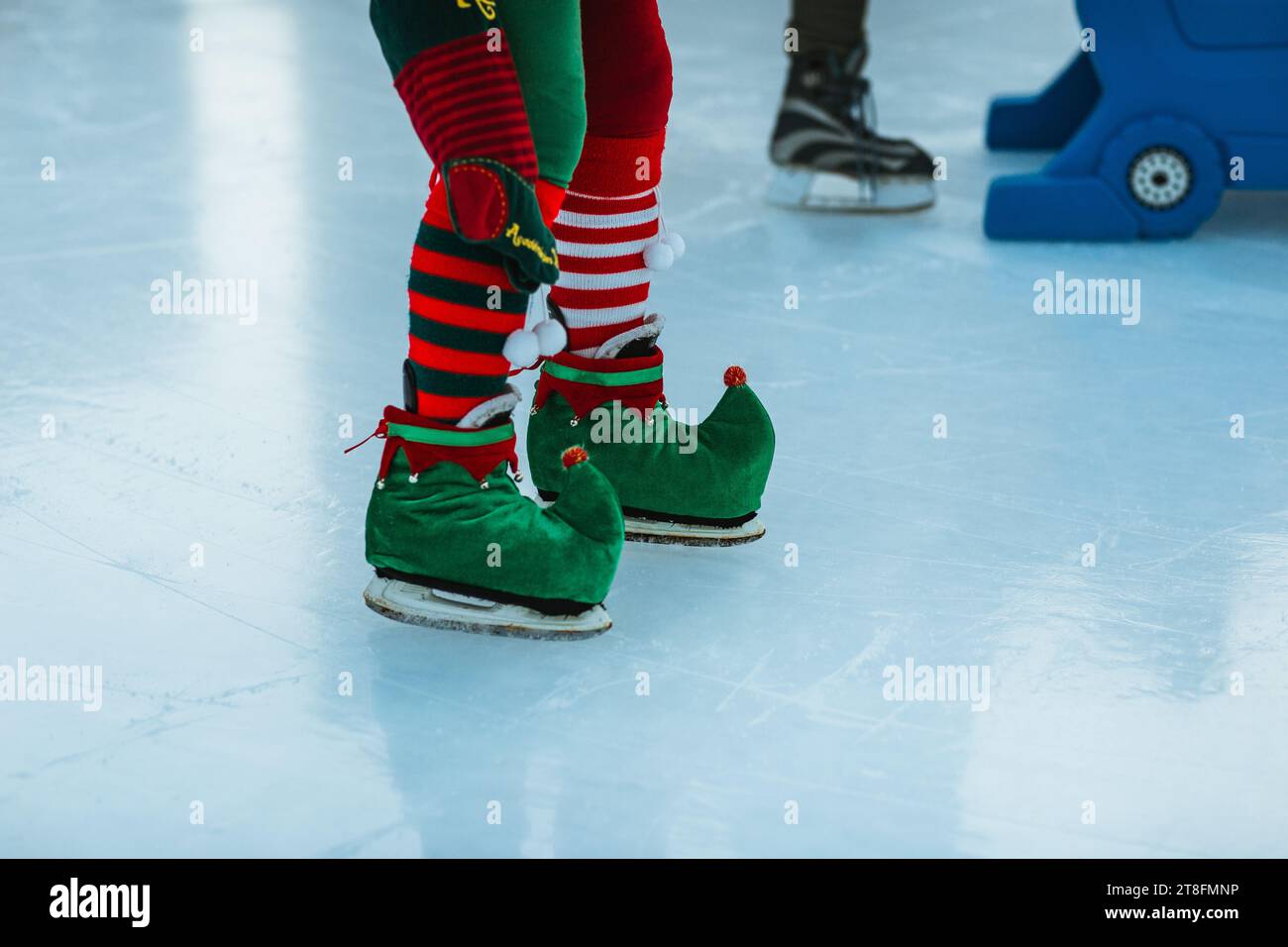Close-up of feet in elf-inspired ice skates, complete with striped ...
