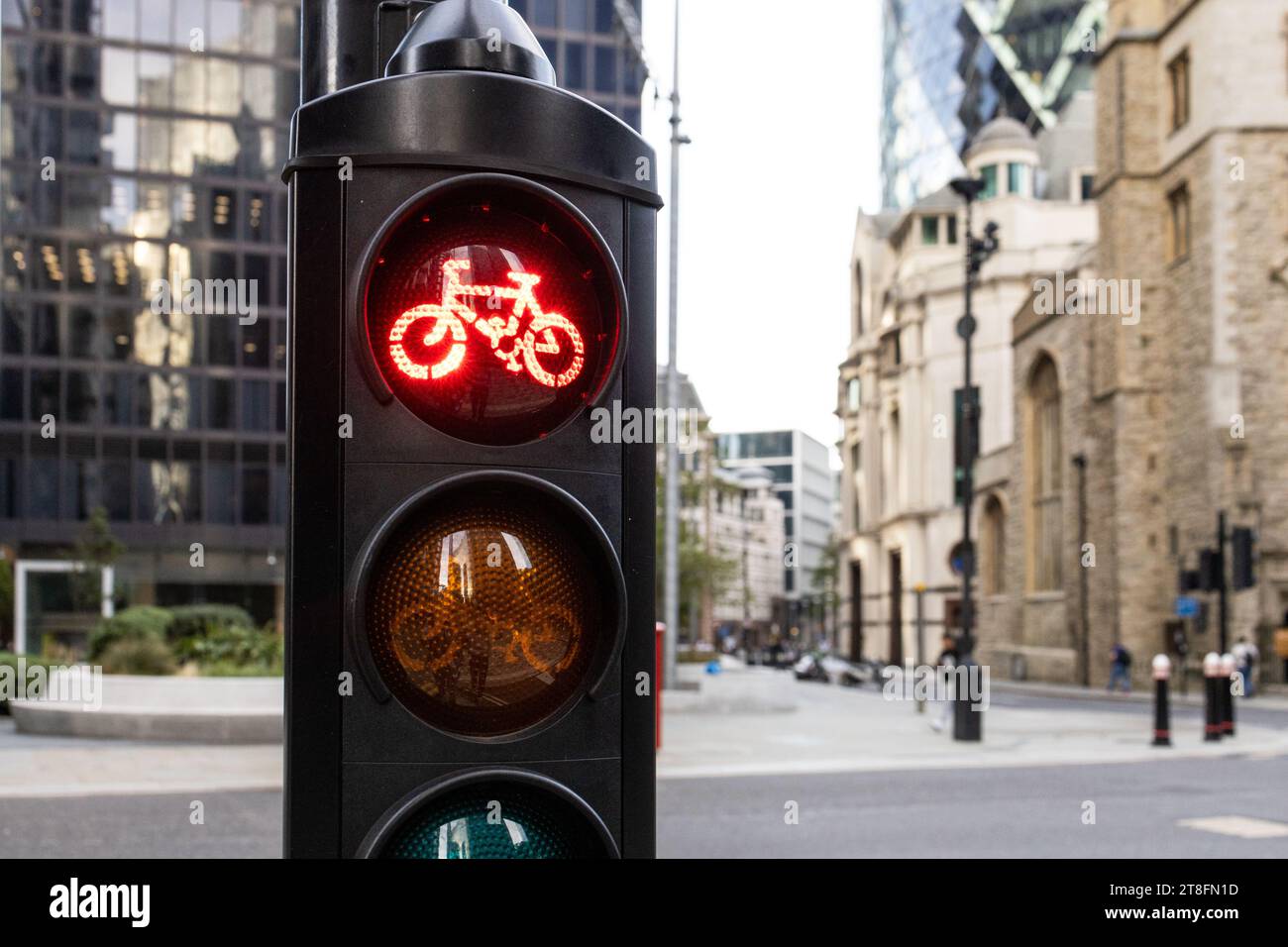 A close-up of a bike-specific traffic signal displaying a red light ...