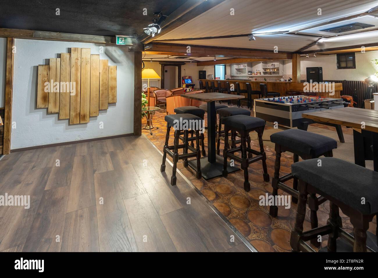 An elegant bar area featuring high stools, sleek wooden counters, and ...