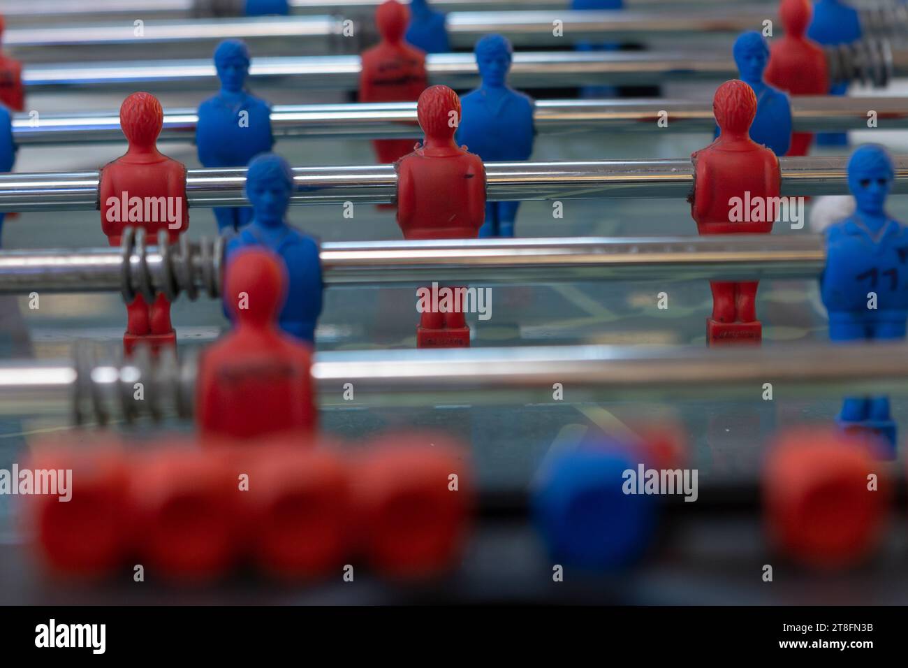 A close-up view of a foosball table game with red and blue miniature ...