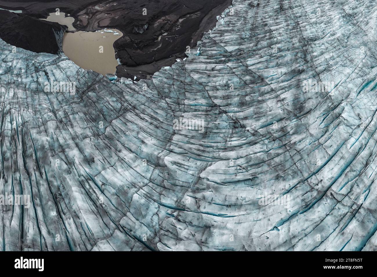 From above aerial drone view of glacier near muddy sea water with blue ...