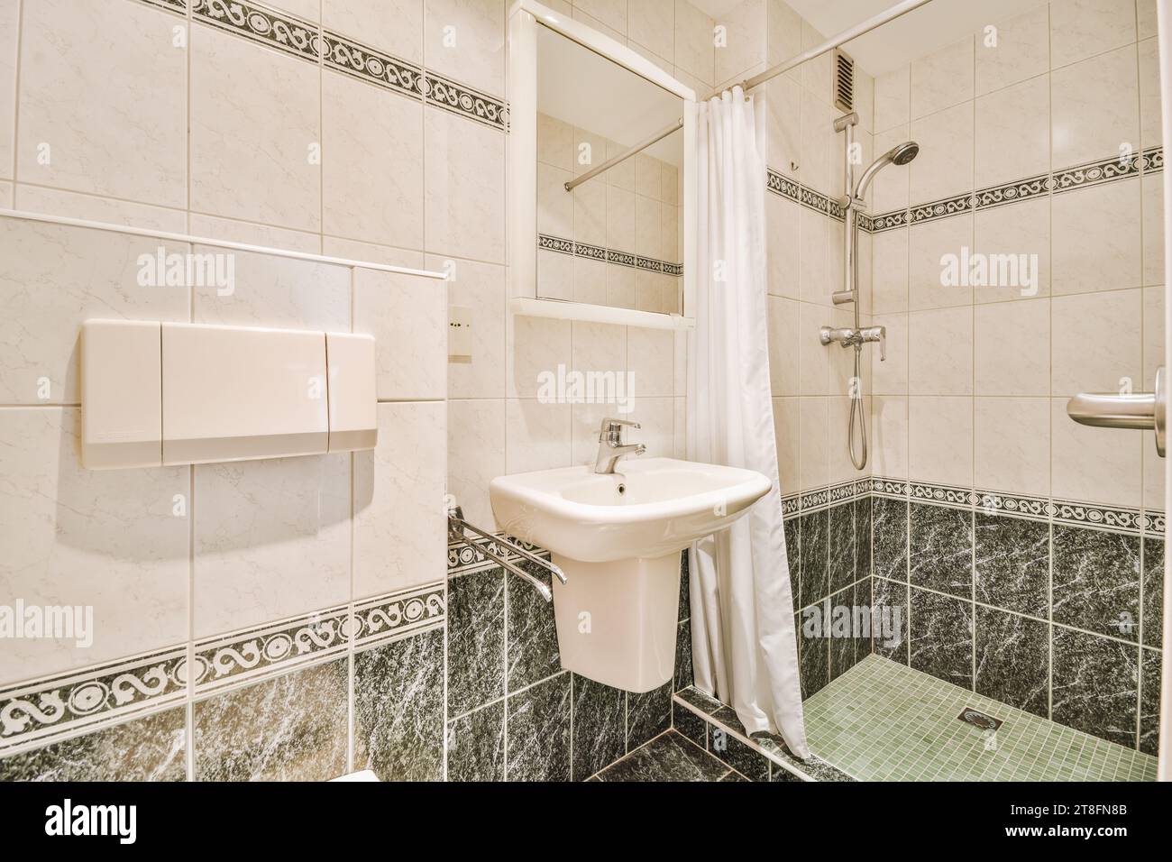 White sink with shower booth and mirror in stylish tiled bathroom at ...