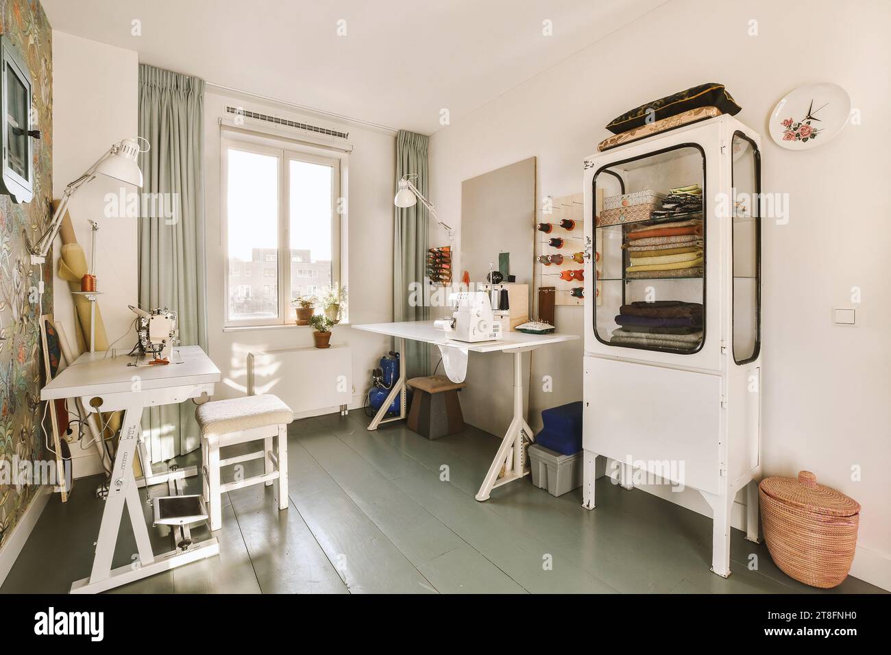 Interior of small workspace with sewing machine and desk with various ...