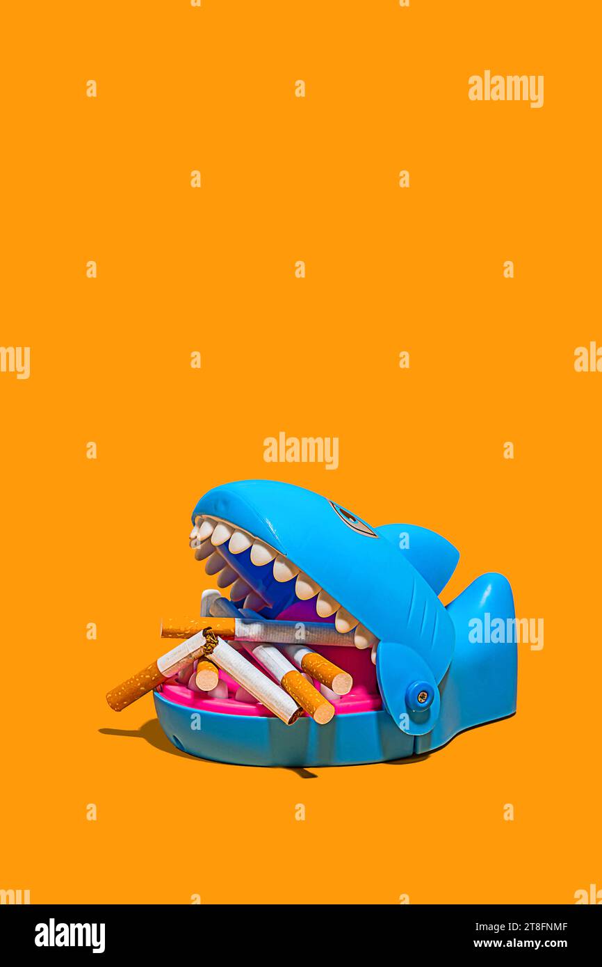 Side view of vibrant blue plastic toy shark with opened mouth with ...