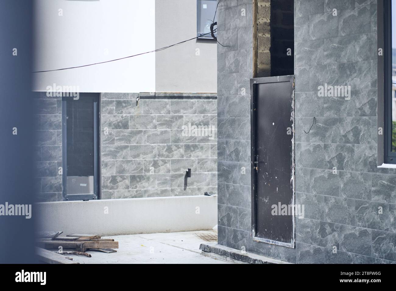 A hotel under construction, iron entrance doors, the exterior of the ...