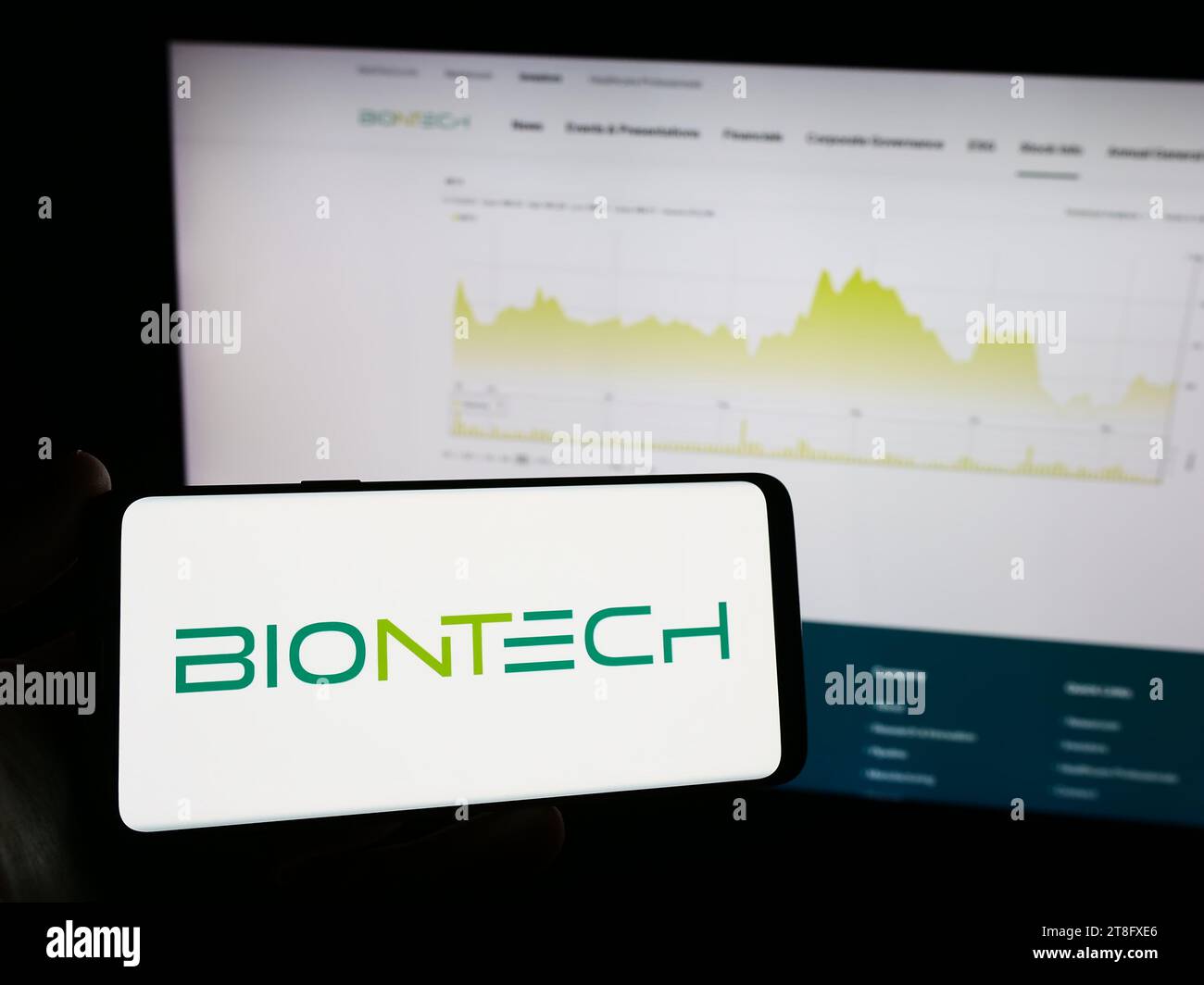 Person holding mobile phone with logo of German biotechnology company ...