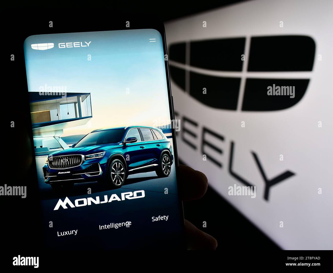 Person holding smartphone with web page of Chinese car manufacturer ...