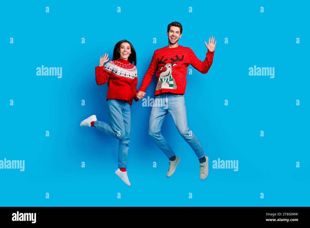 Full length photo of two friendly positive pleasant people hold hands ...