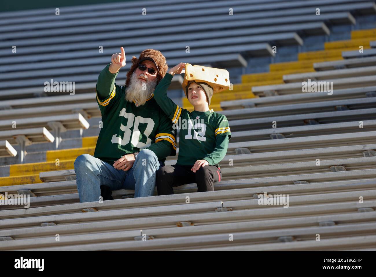 A football fan watches practice during an NFL football game between the ...