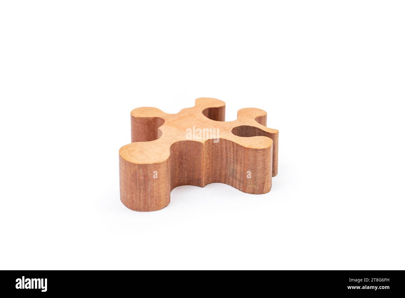Fluid shaped wooden puzzle piece isolated on white background, abstract ...