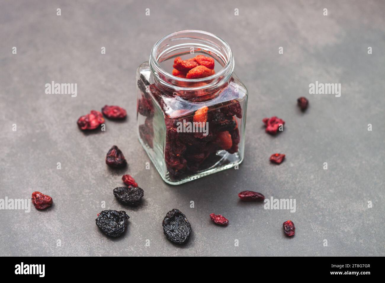 Top view red cranberries inside a transparent jar, with black ...