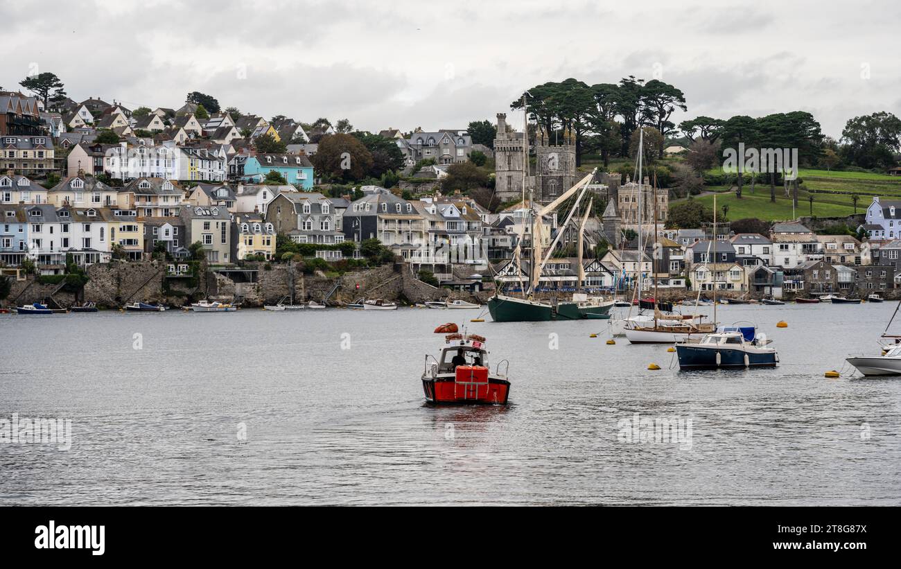 Boats are moored in the eastuary of the Fowey river, with Fowey town ...
