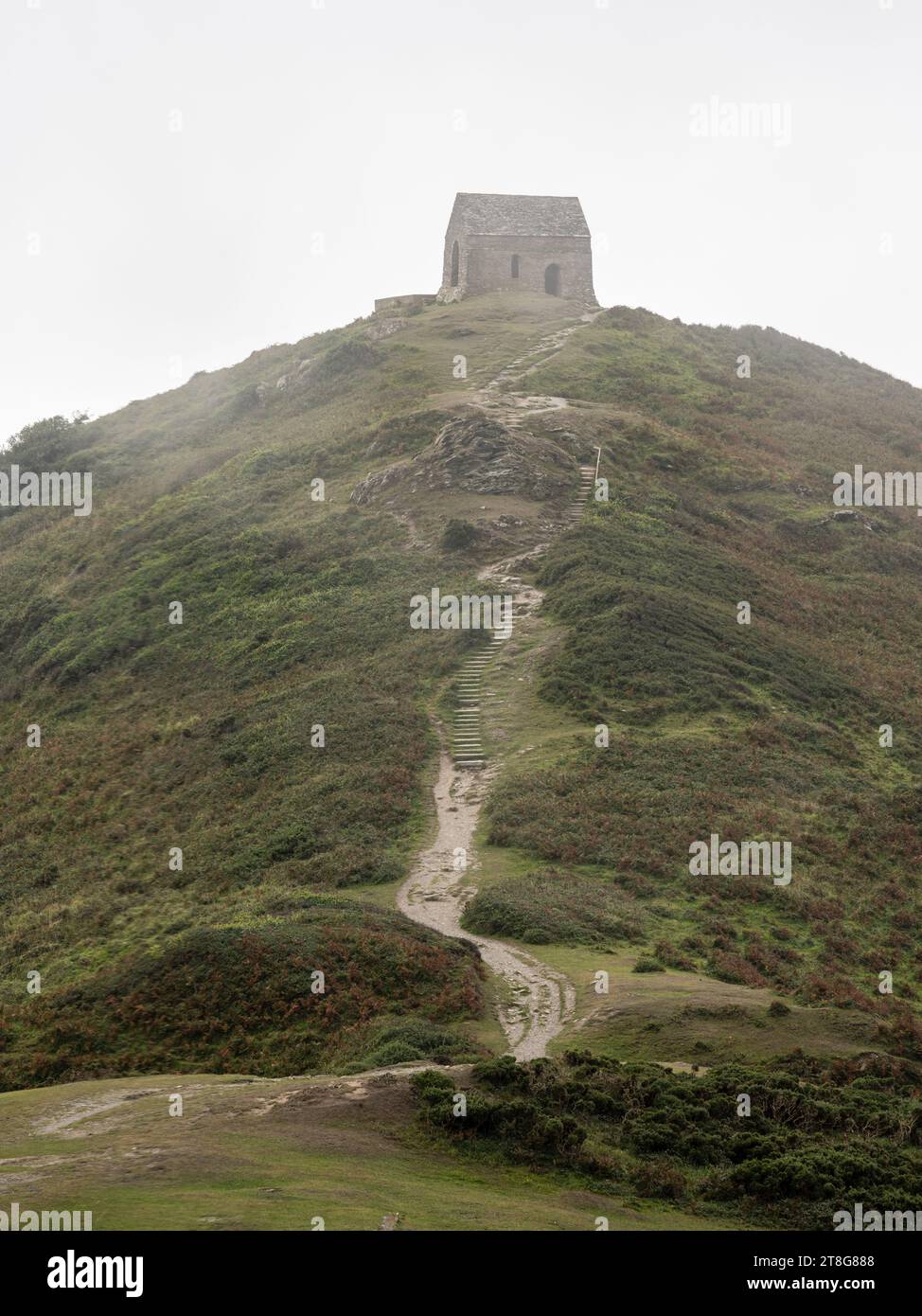 Sea mist blows over the hilltop chapel of Rame Head on the Cornish ...