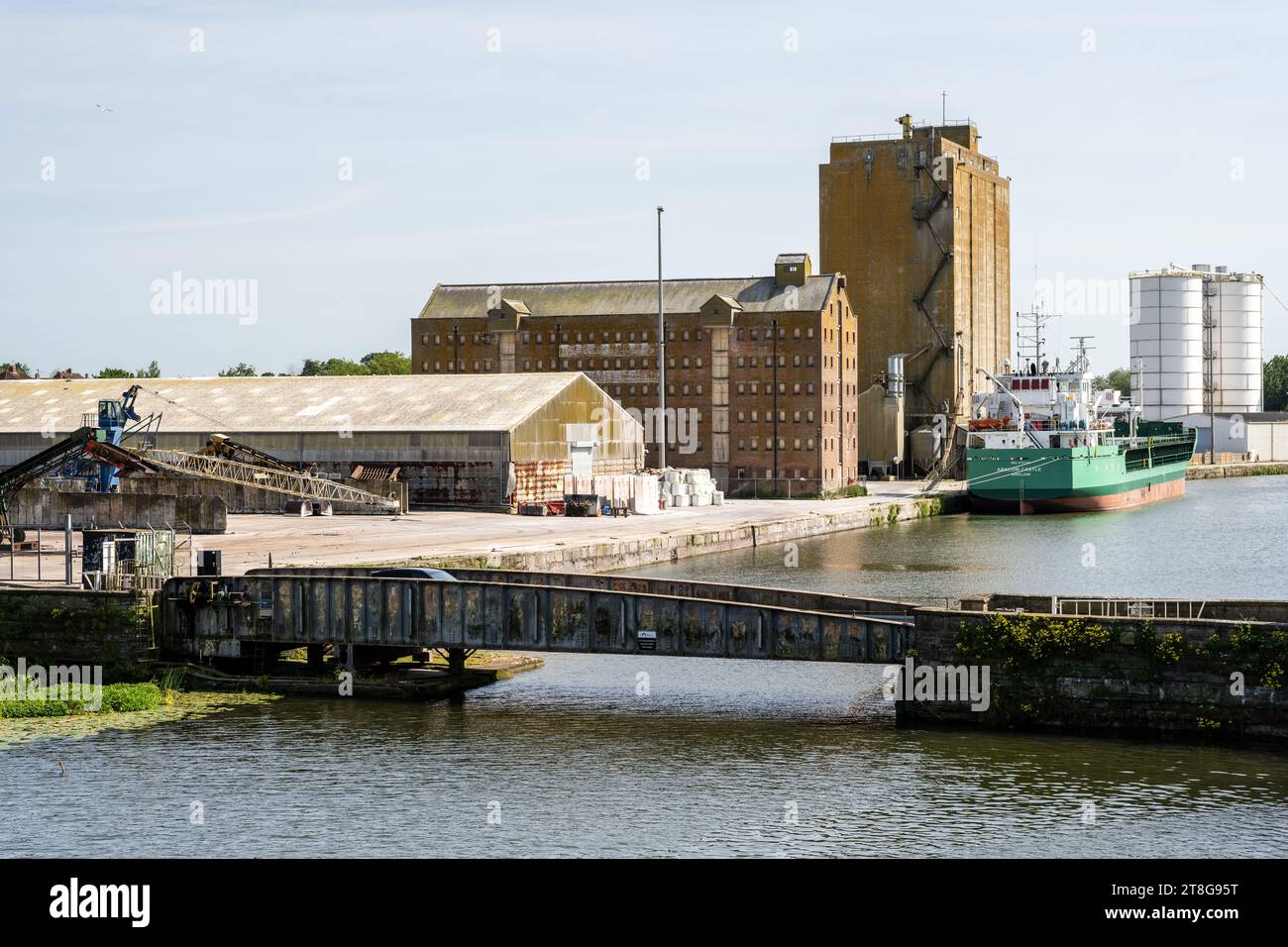 Warehouses and silos rise from the quayside of Sharpness Dock in ...