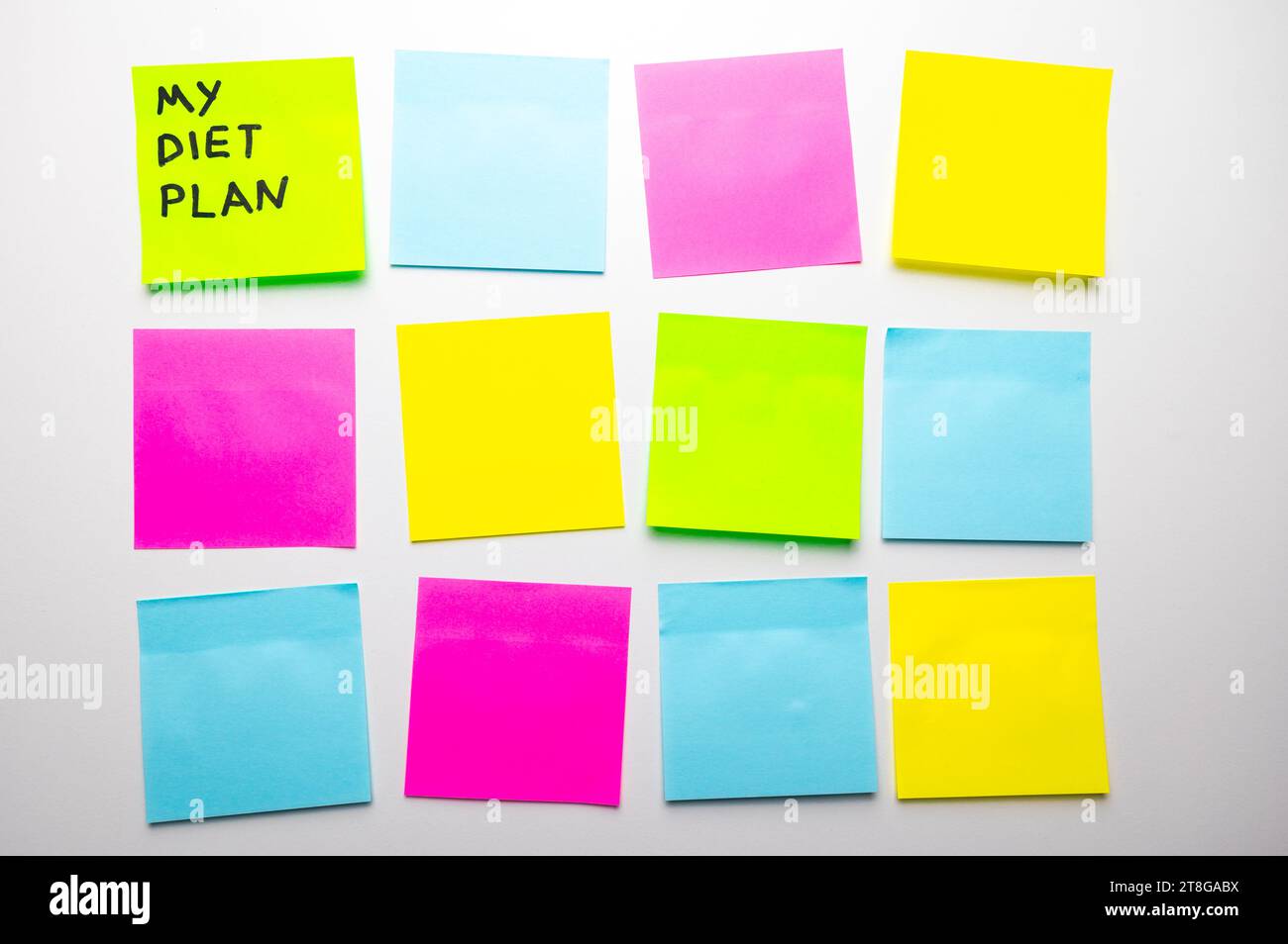 Colorful sticky sheets, and "diet plan" text on white surface. Drawing ...
