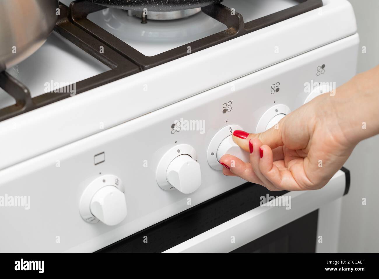 a woman's hand rotates the selector on a gas stove. woman's hand turns ...