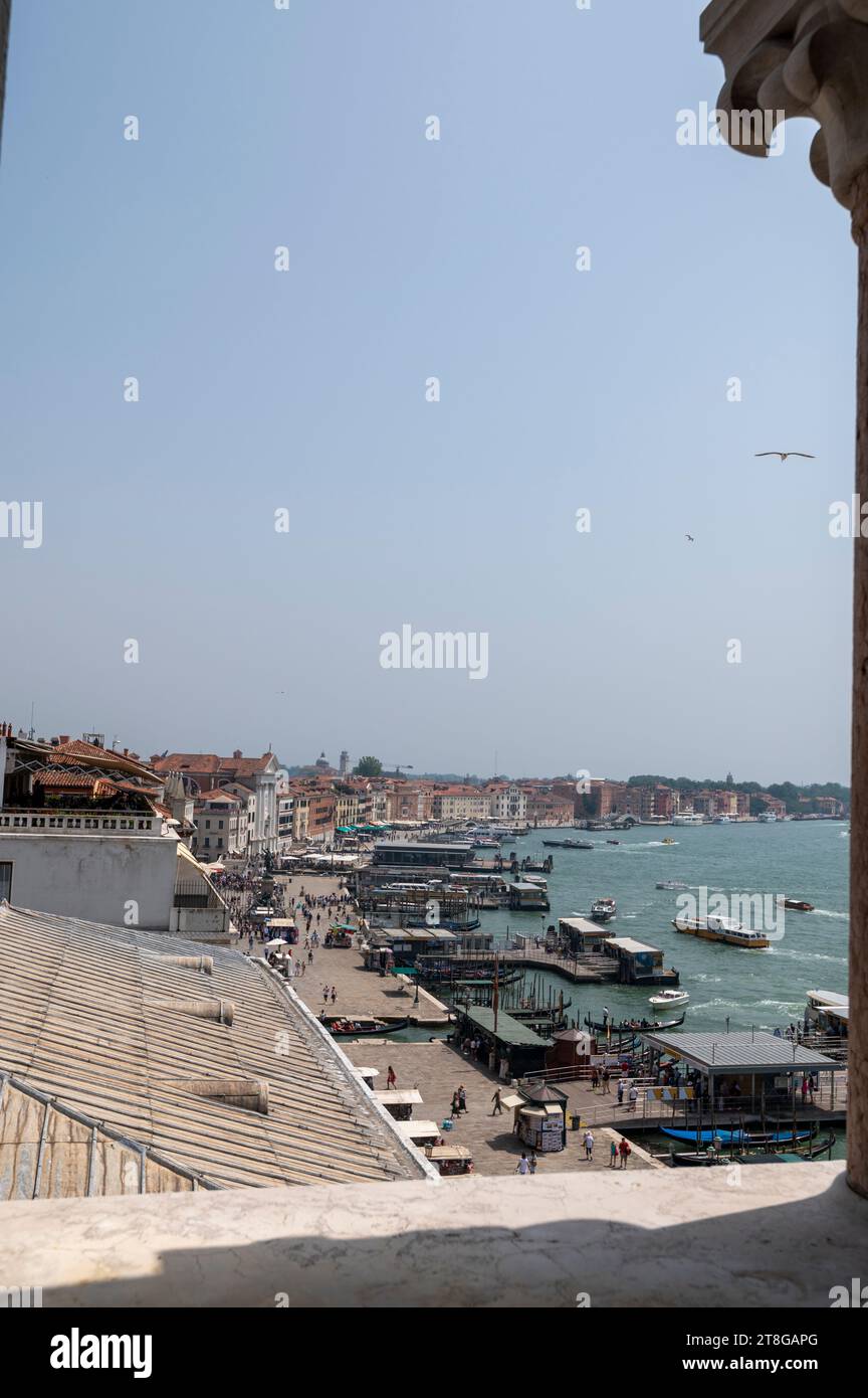 A window view from the Doge Palace of the busy waterfront esplanade of ...