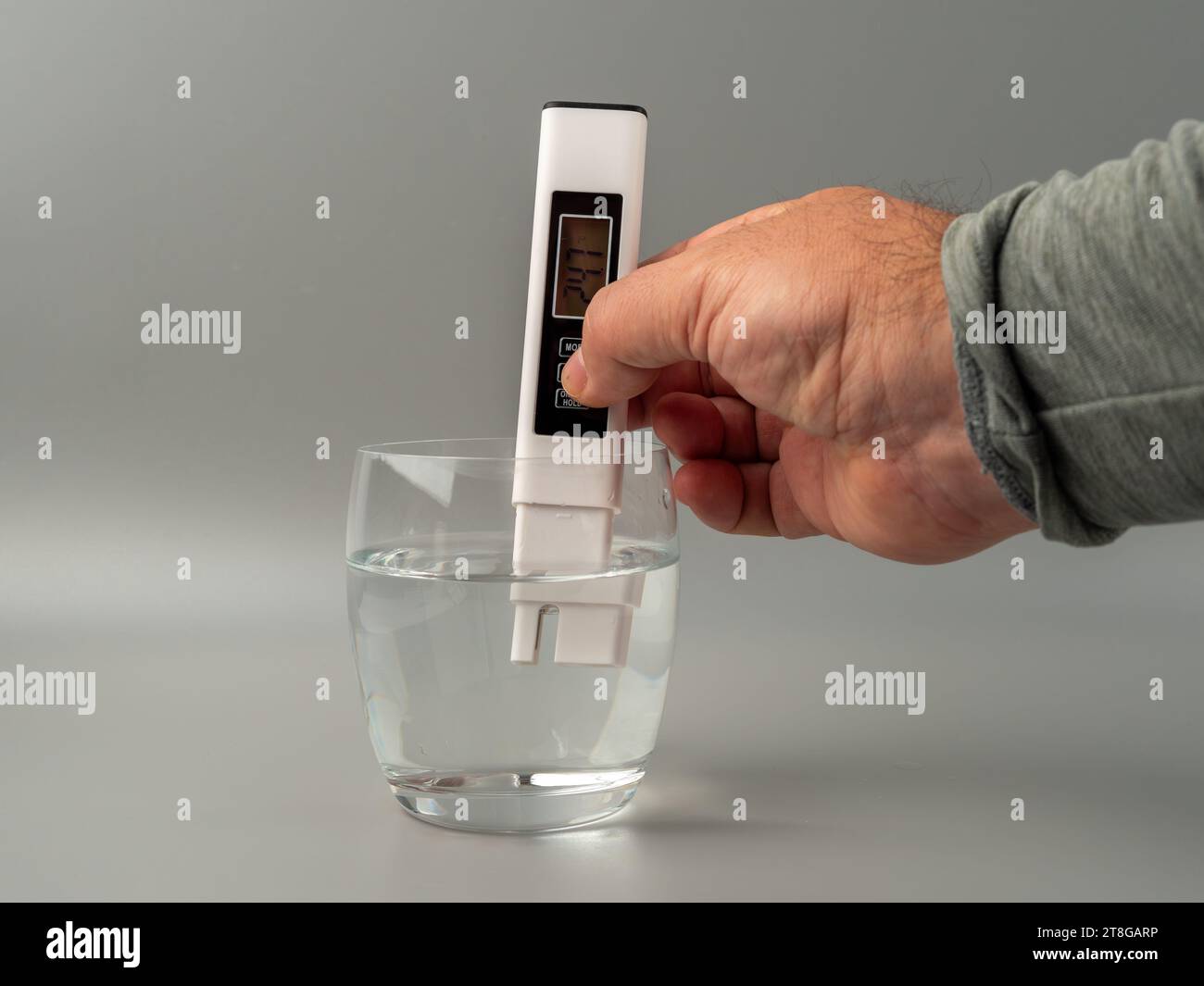 Water quality tester on a gray background. Device for measuring water ...
