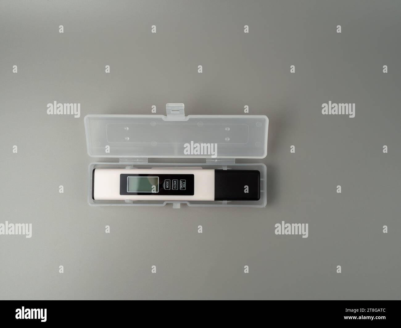 Water quality tester on a gray background. Device for measuring water ...
